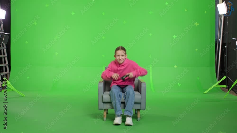 Young caucasian girl sitting on a chair, Playing and winning in Video ...