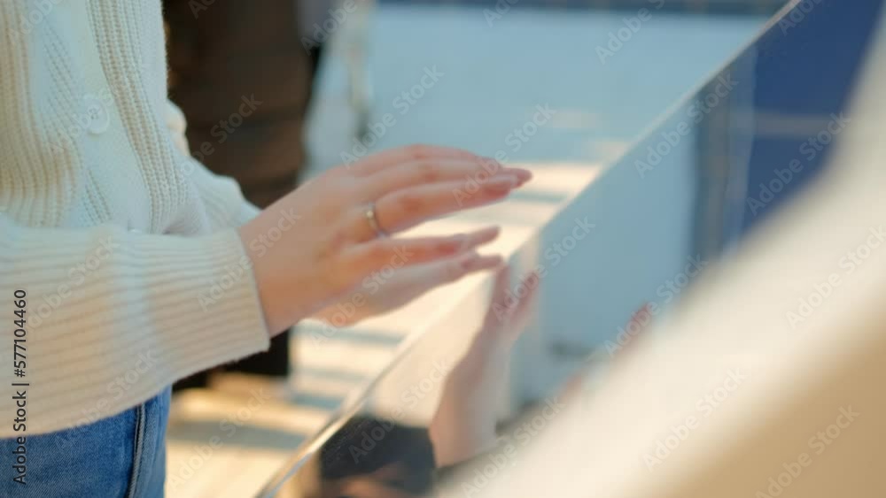 Woman using touchscreen terminal in mall. Detail view outstretched ...