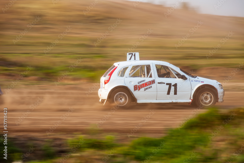 Rally off-road car make a turn with the clouds and splashes of sand ...