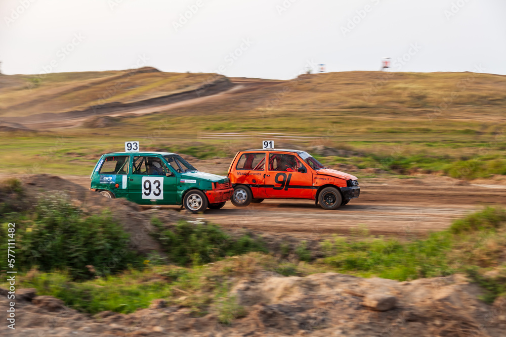 Rally off-road car make a turn with the clouds and splashes of sand ...