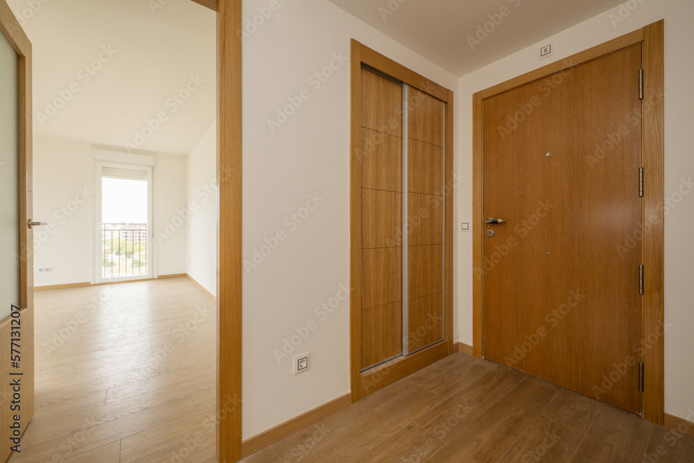 Entrance hall of an empty house with an oak access door to match the ...