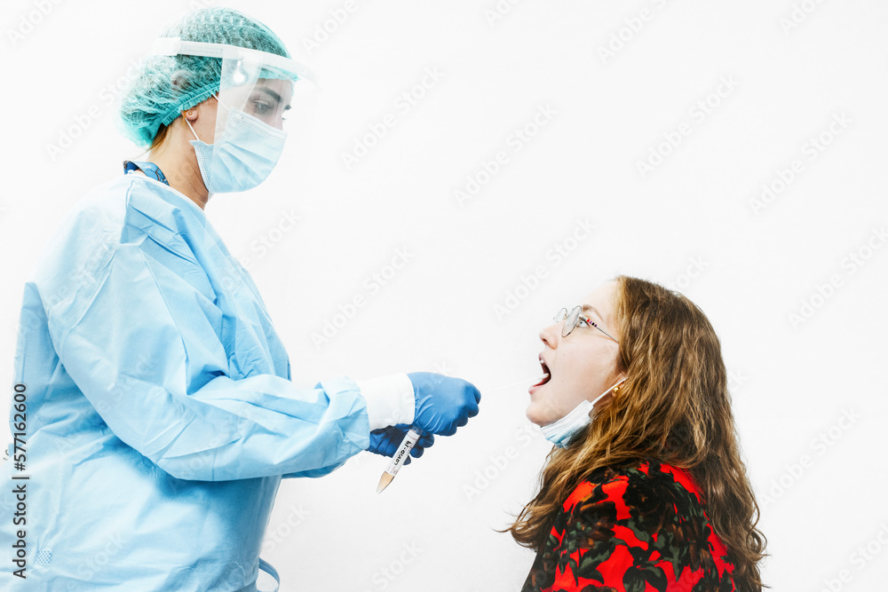 A female doctor do a covid test (PCR) to a patient by using a nasal ...