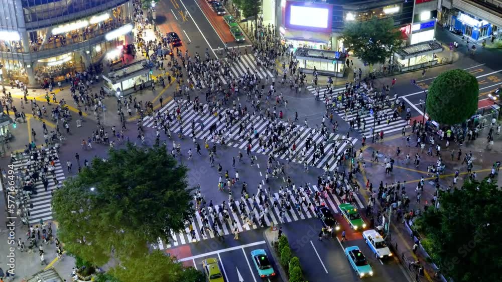 Looking down at thousands of people crossing the famous Shibuya ...