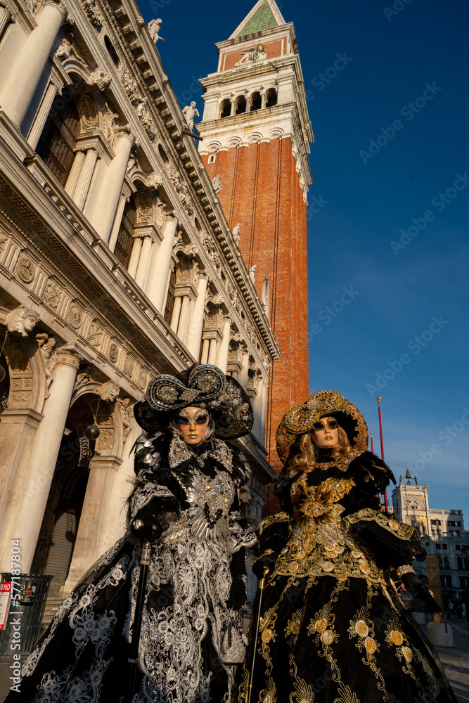 Costumed carnival participants and revellers mingle with tourists ...