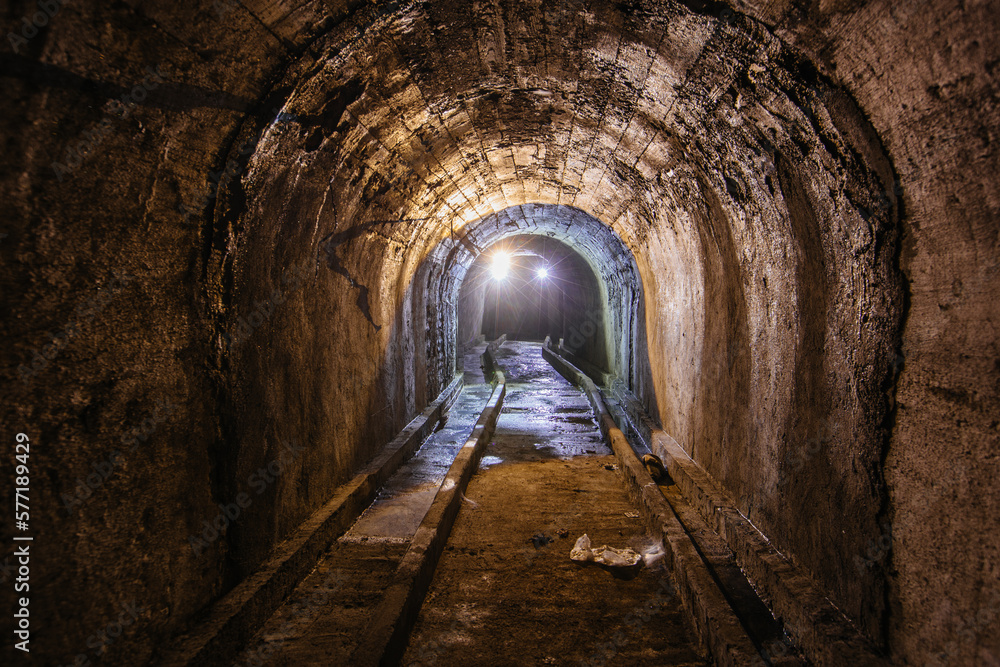 Vaulted tunnel with concrete walls in old abandoned bunker, mine ...