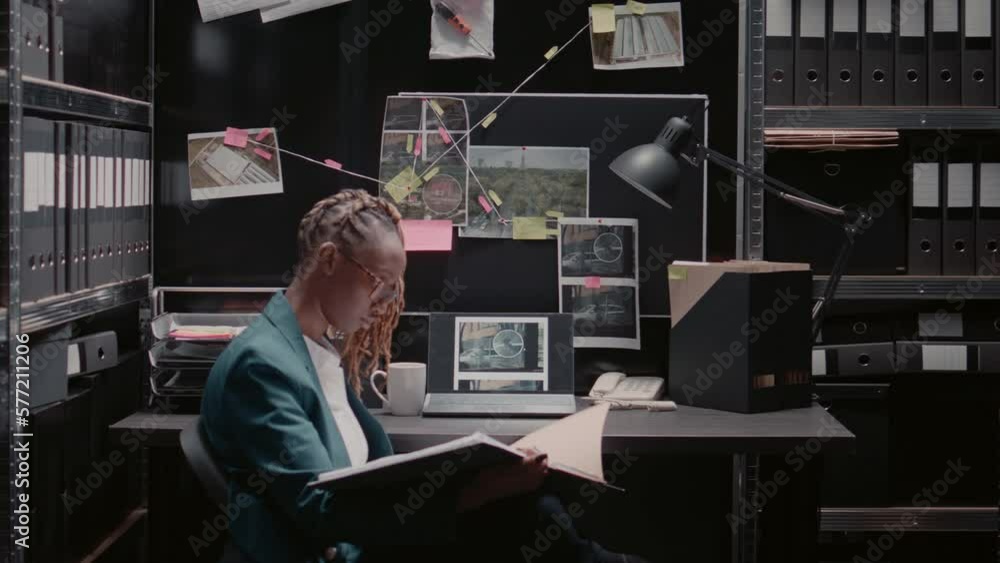 Private investigator reviewing new case evidence on detective board ...