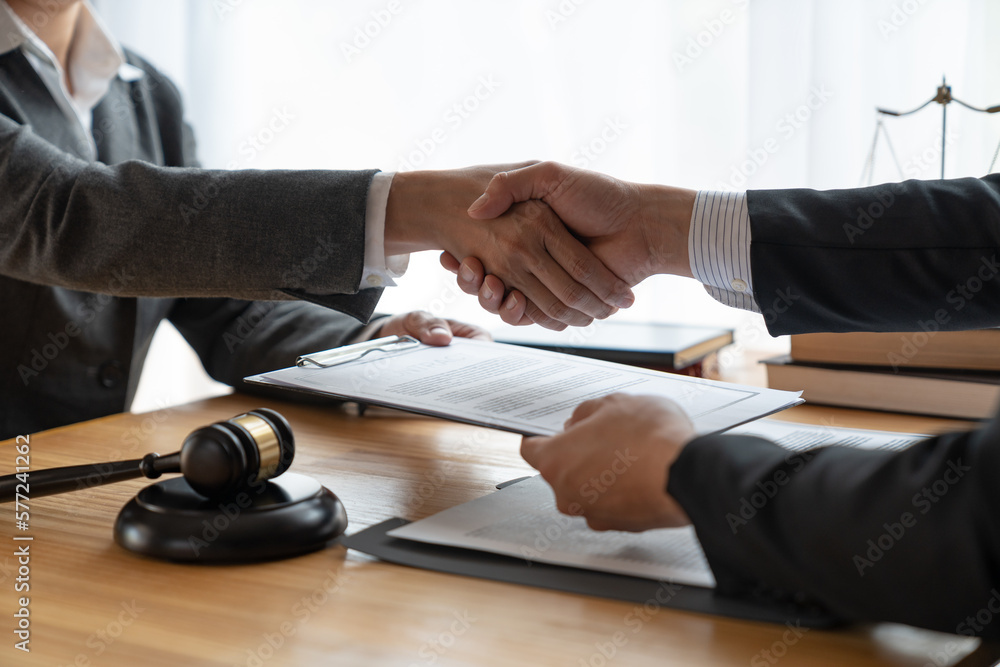 Lawyers shake hands with business people to seal a deal with partner ...