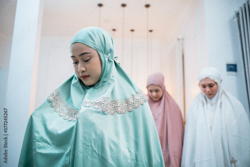 Muslim women wearing Muslim clothes with hijab praying in congregation ...