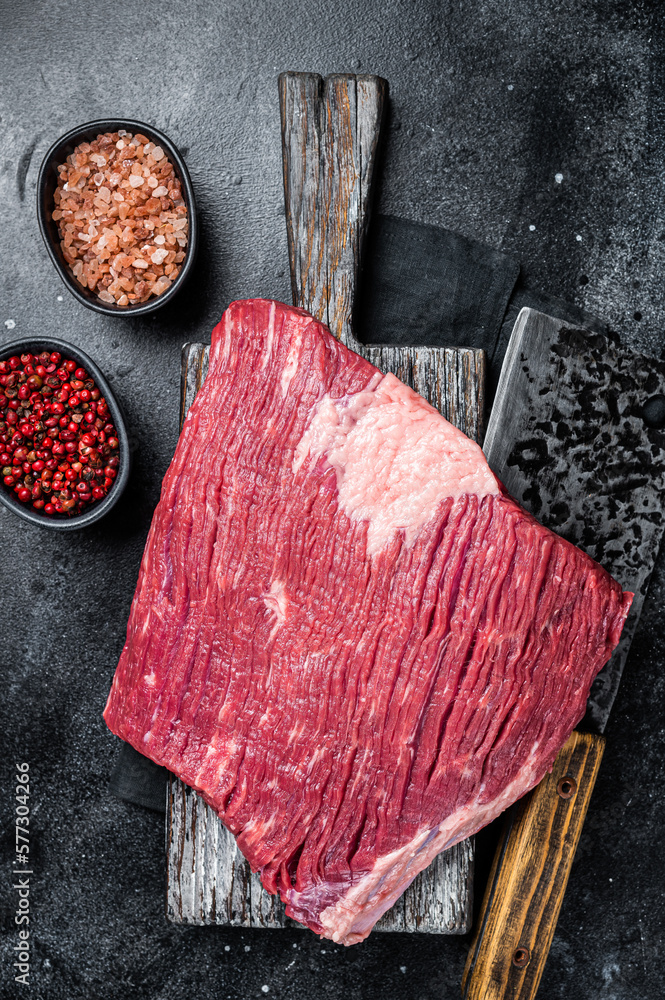 Uncooked Raw beef brisket meat on butcher board. Black background. Top ...