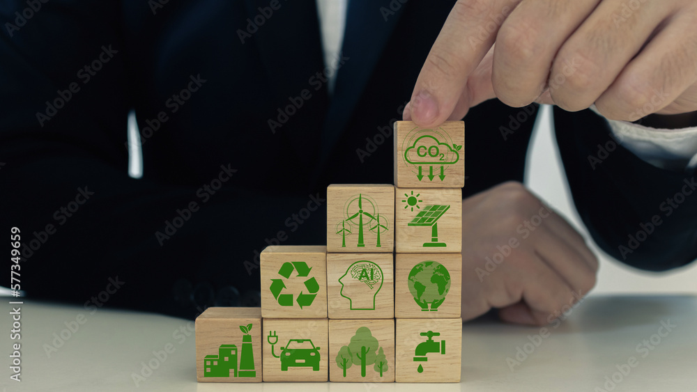 ESG environmental sustainable and Net zero and carbon neutral concept.Businessman holding wooden ...