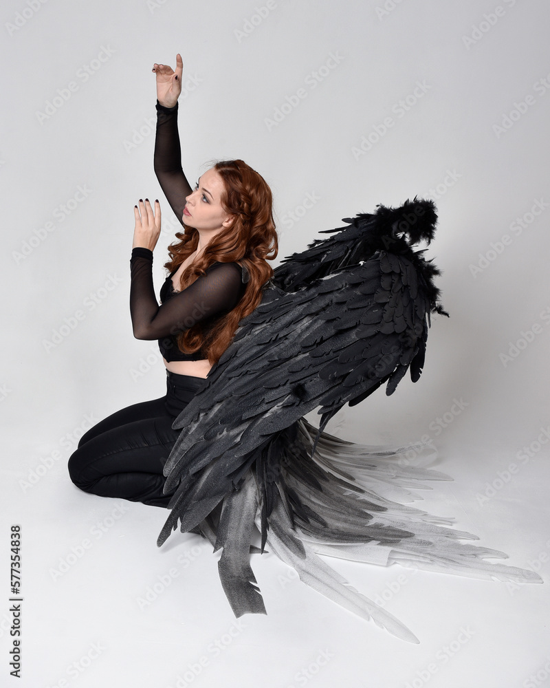 Full length portrait of beautiful woman with long red hair wearing ...