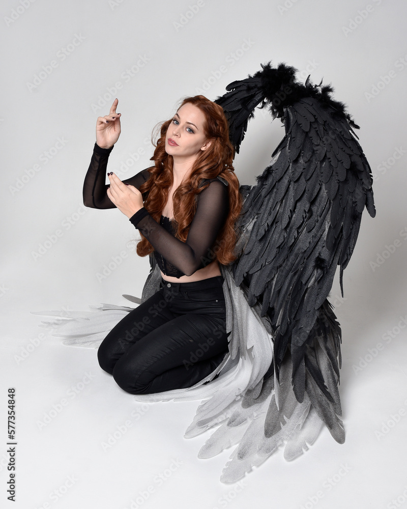 Full length portrait of beautiful woman with long red hair wearing ...