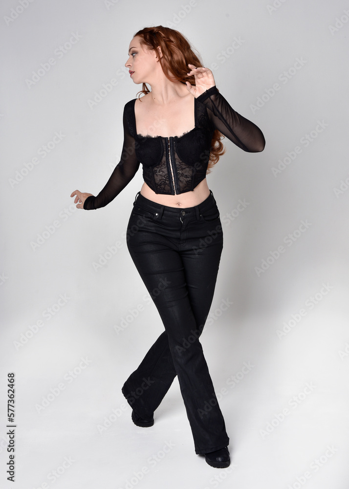 Full length portrait of beautiful woman with long red hair wearing ...