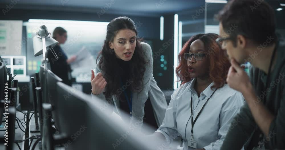 Team of Three Talented Young Software Engineers Use Computer to Discuss ...