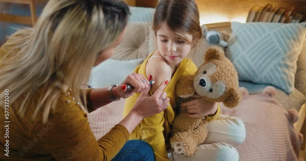 Little girl diabetic receives insulin injection from his mother into ...