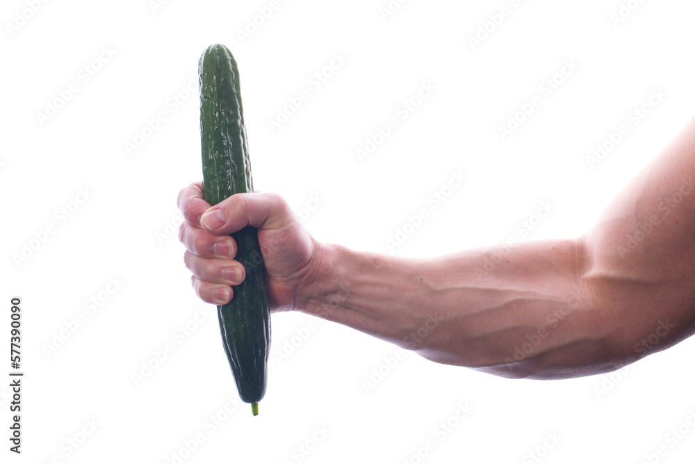 Strong fit muscular male holding a cucumber in his right hand ...