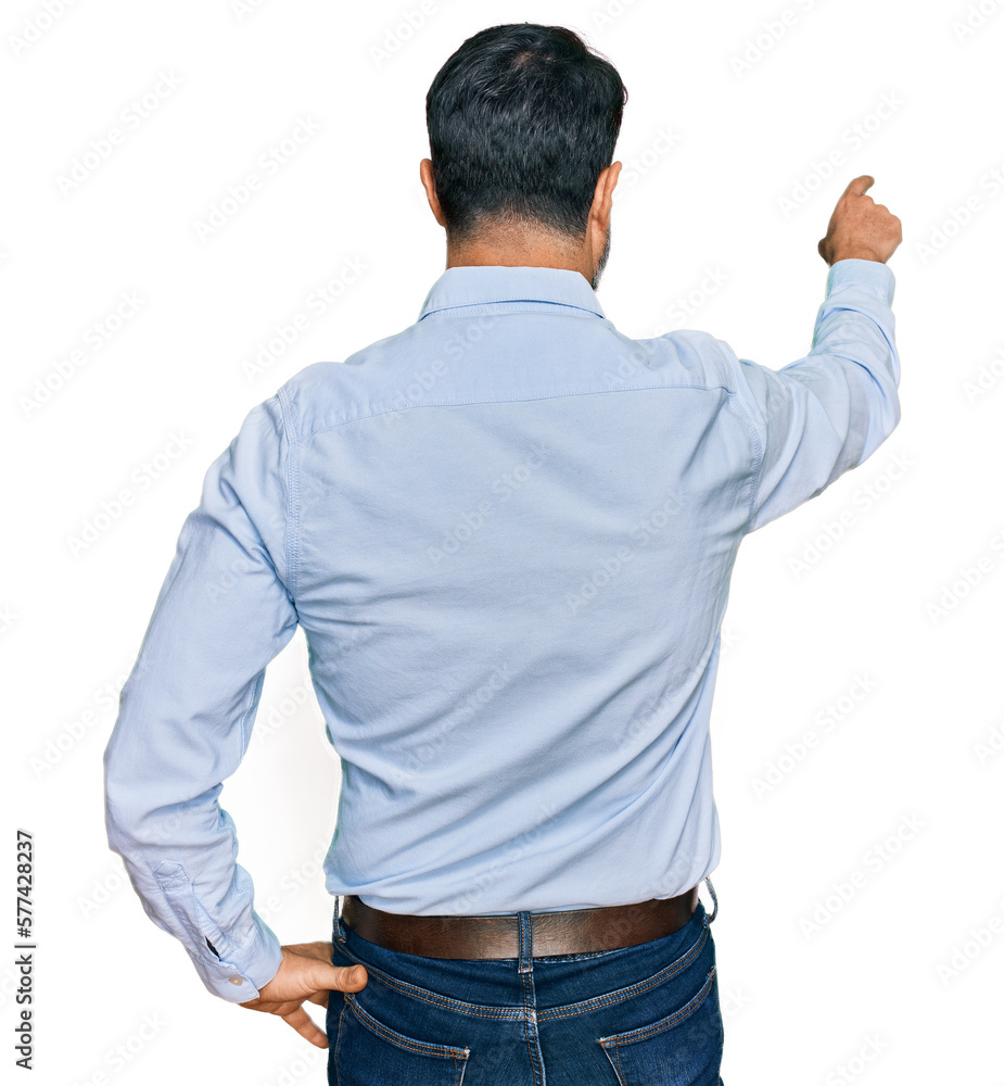 Middle aged man with beard wearing business shirt posing backwards ...