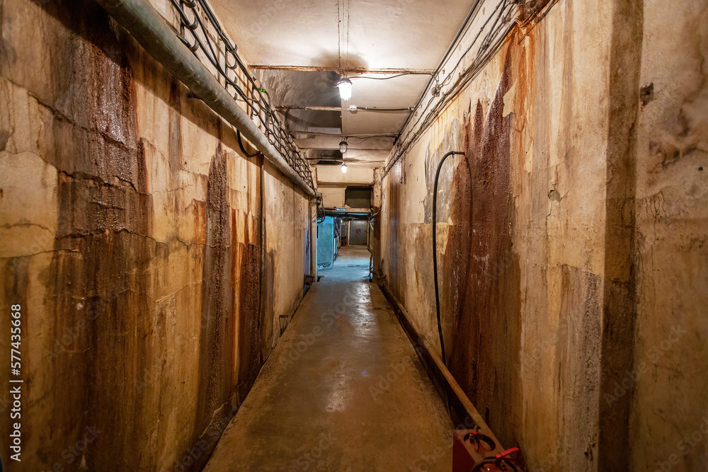 Abstract dark corridor of military bunker interior, grungy old ...