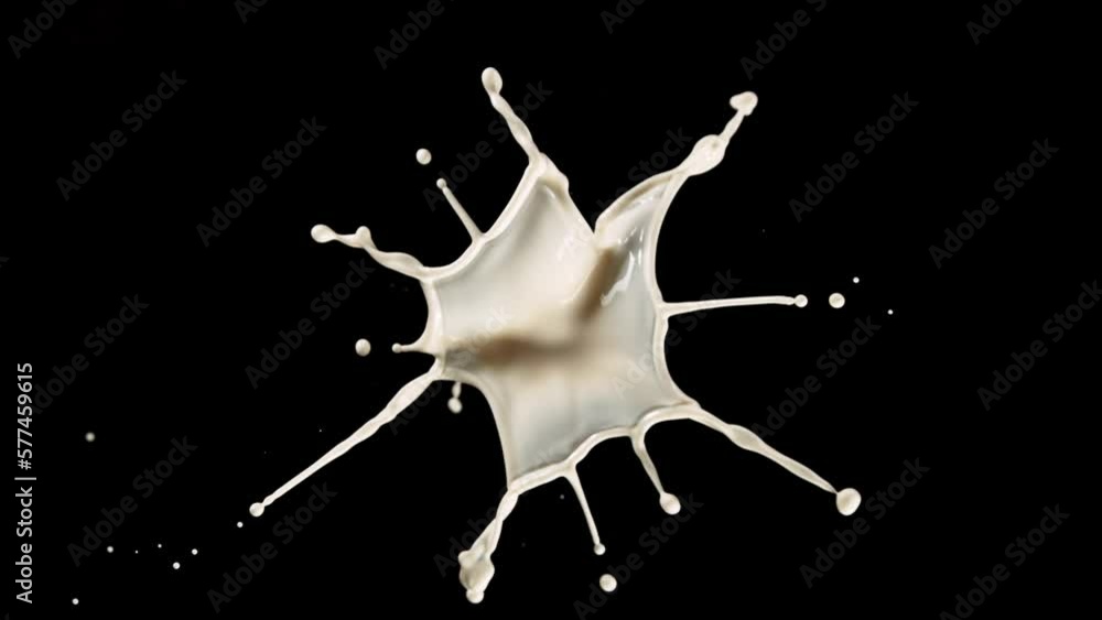 Vidéo Stock Realistic super slow motion of flying milk splash on black ...