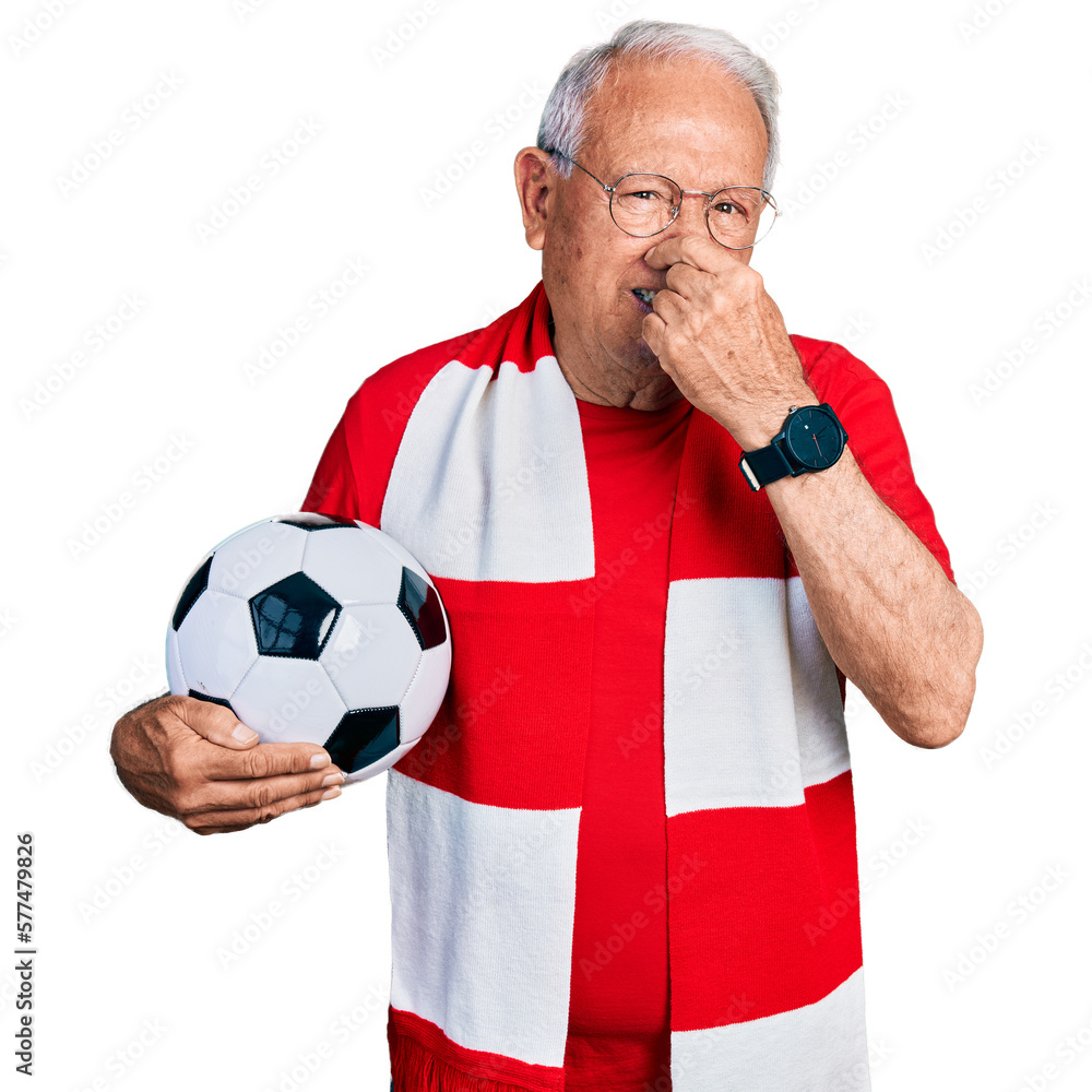 Senior man with grey hair football hooligan holding ball smelling ...