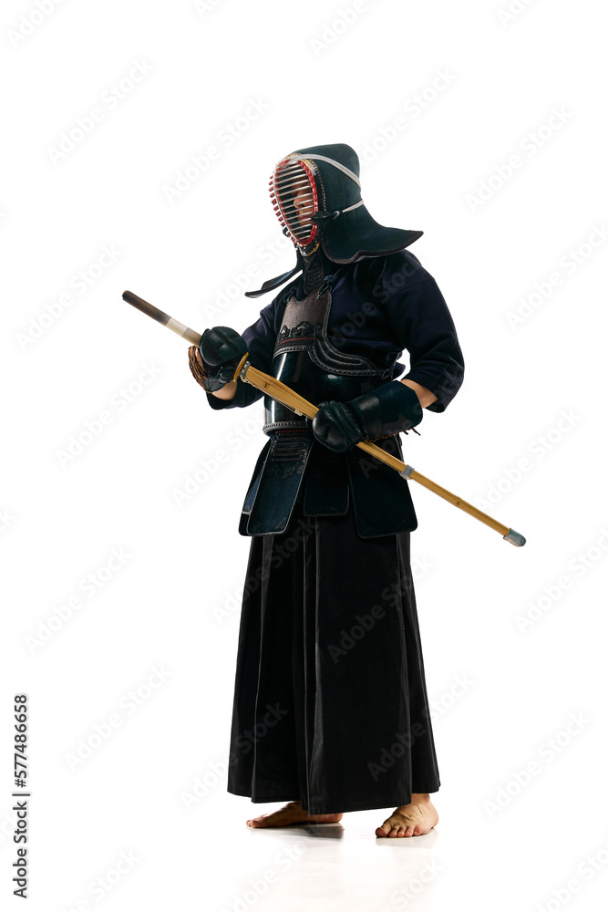 Portrait of man, professional kendo athlete in uniform posing with ...