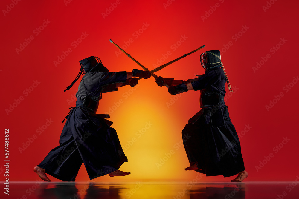 Dynamic image of two men, professional kendo athletes training with ...