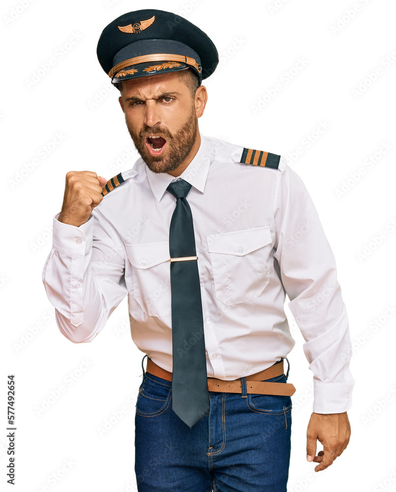 Handsome man with beard wearing airplane pilot uniform angry and mad ...