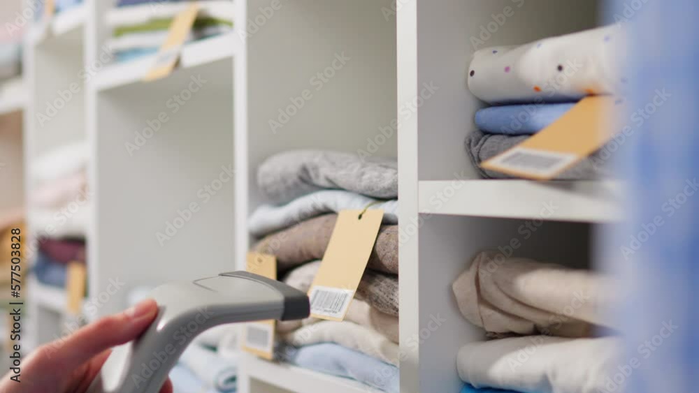 Organized interior, Active woman Slowly Scans a barcode with a scanner ...