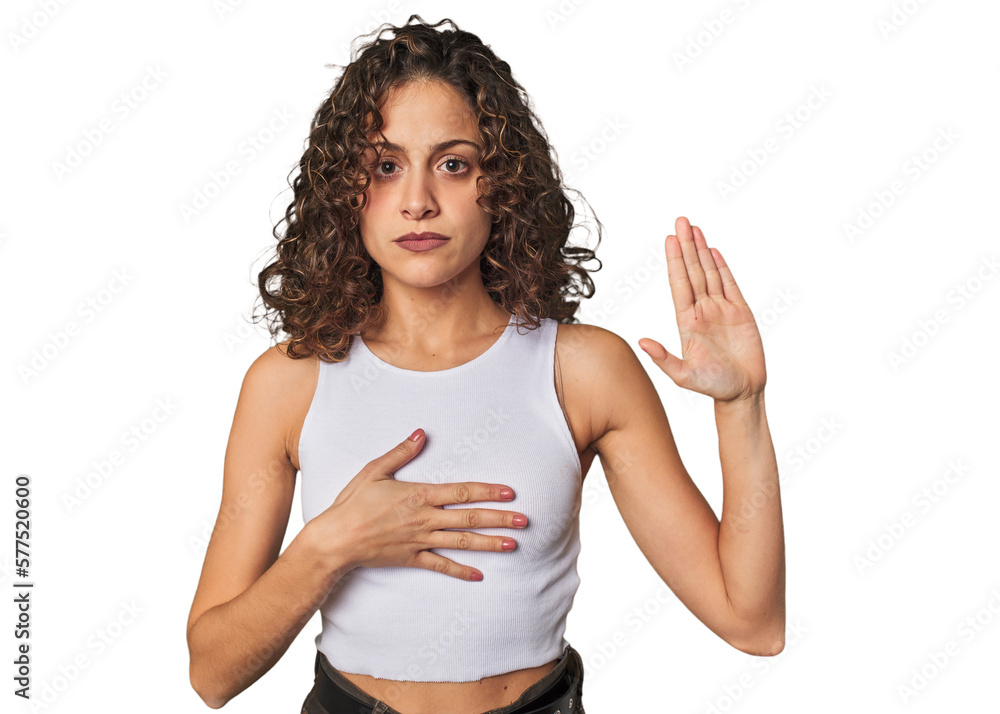 Radiant young woman with stunning curls taking an oath, putting hand on ...