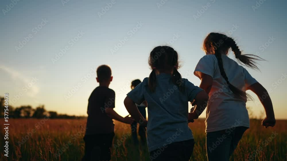 Children running in park at sunset. happy family kindergarten kids ...