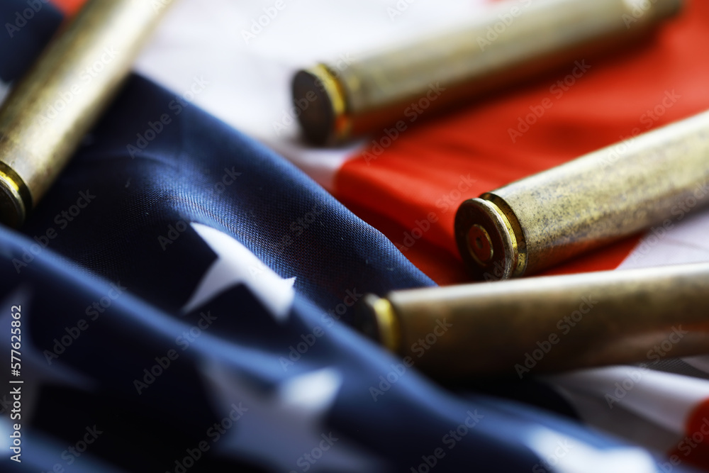 Many bullets cartridges and medals on United States flag. Concept of ...