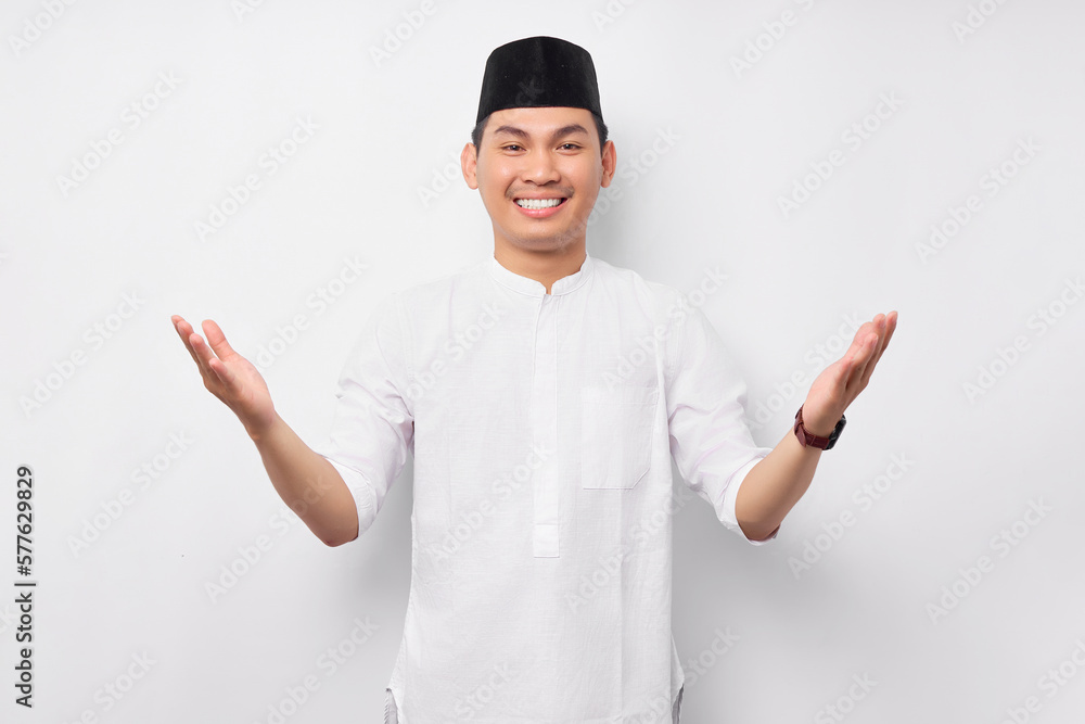 Smiling friendly handsome young Asian Muslim man wearing Arabic costume ...
