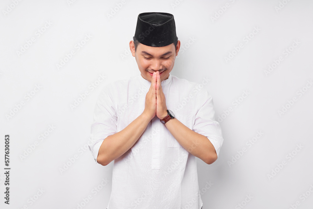 Young Asian Muslim man in Arabic costume standing with hand praying to ...