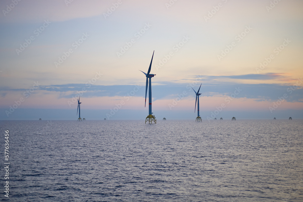 Electricity production by offshore wind turbine farm in the sea. Clean ...