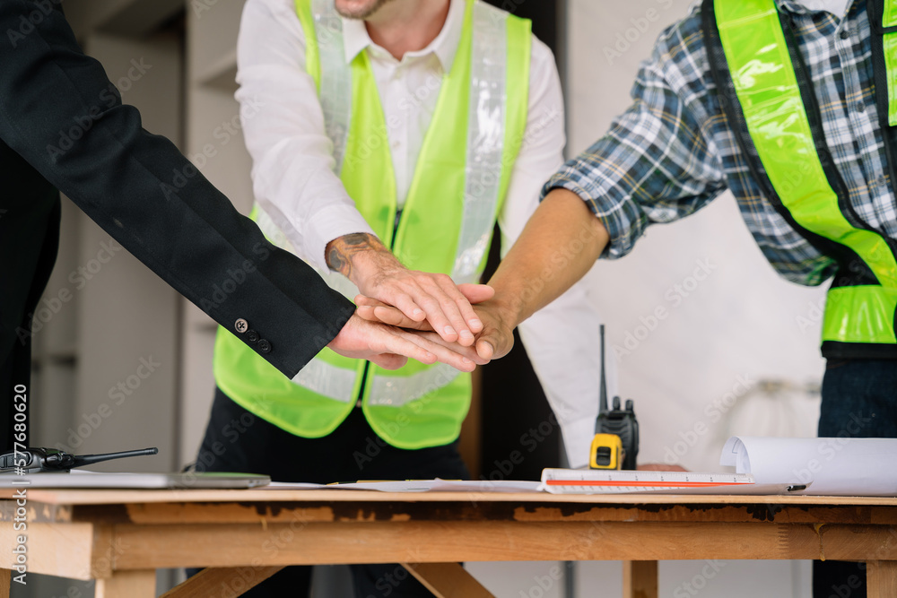 Architect team and Colleagues mixed race, join hands to join forces to ...