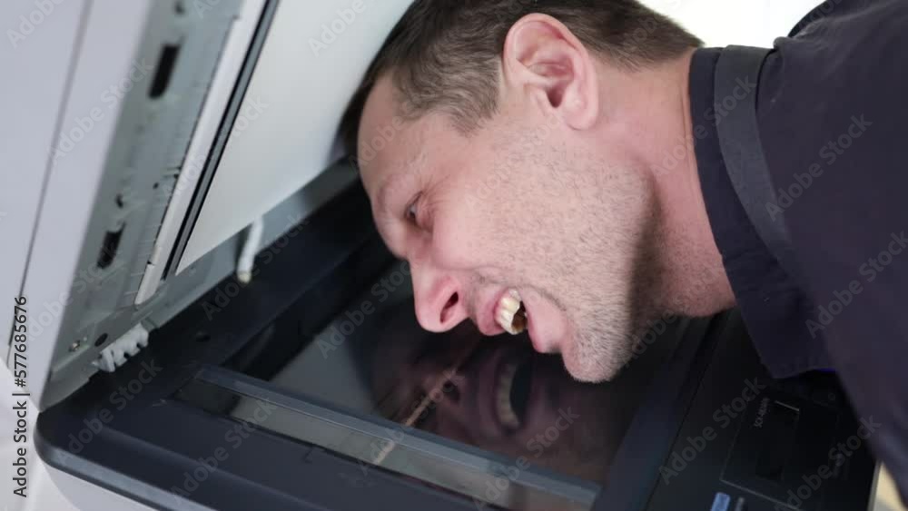 The process of scanning a man's face. Scanner in operation scans a ...