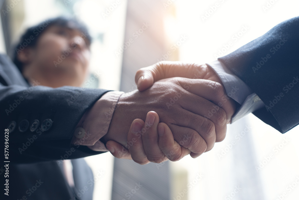 Businessmen making handshake in the city, business etiquette ...