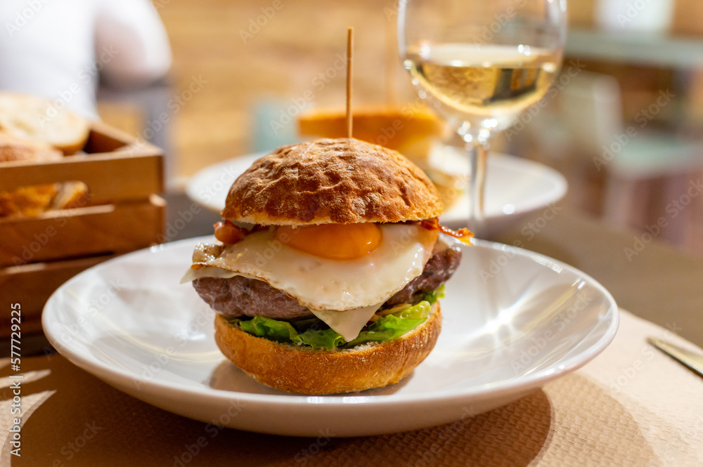 Tasty burger with white crispy ban, beef burger, egg, green lettuce and ...
