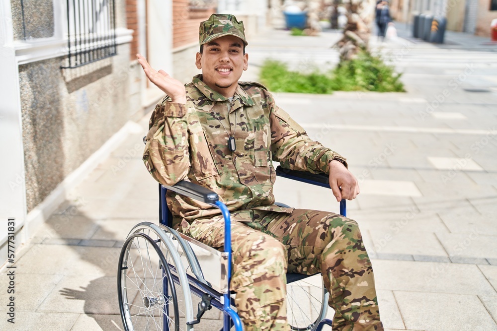 Young arab man wearing camouflage army uniform sitting on wheelchair ...