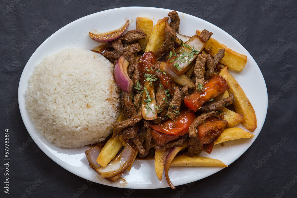 Plate full of typical Peruvian lomo saltado Stock Photo | Adobe Stock