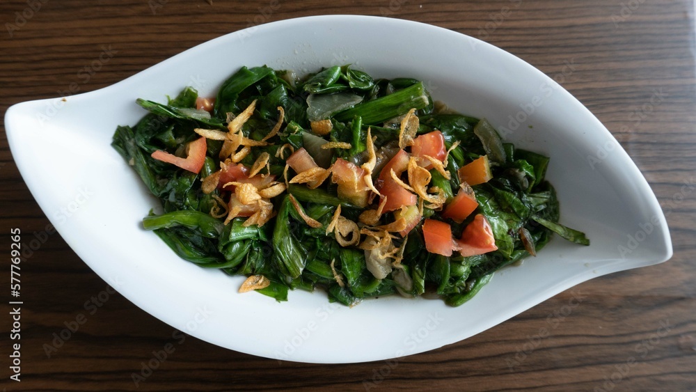 green genjer vegetables that have been sautéed with red chilies and ...