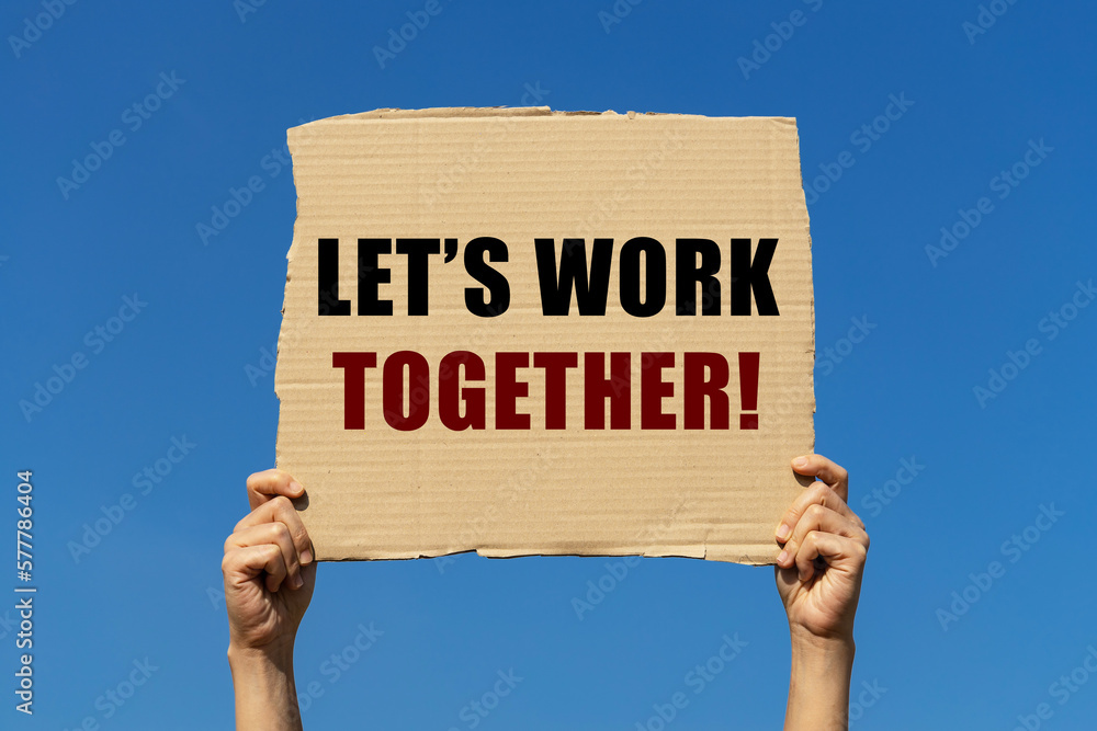 Let's work together text on box paper held by 2 hands with isolated ...