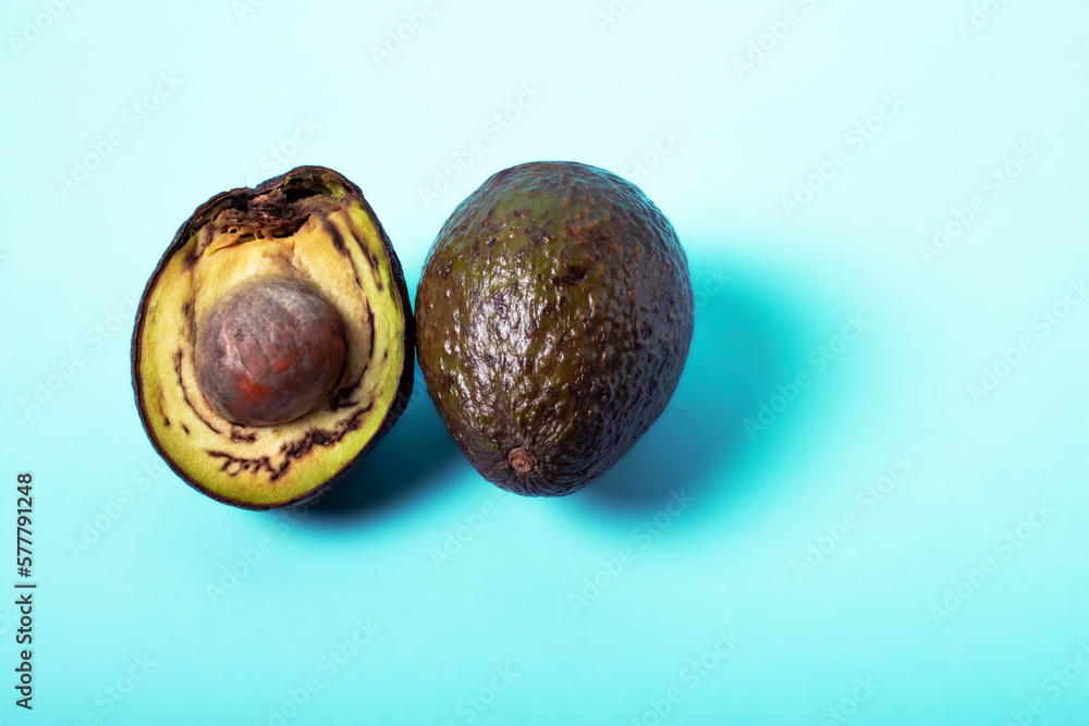 Rotten avocado, overriped, bad avocado. Half sliced fruit, freegan food ...