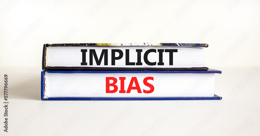 Implicit bias symbol. Concept words Implicit bias on books. Beautiful white table white ...