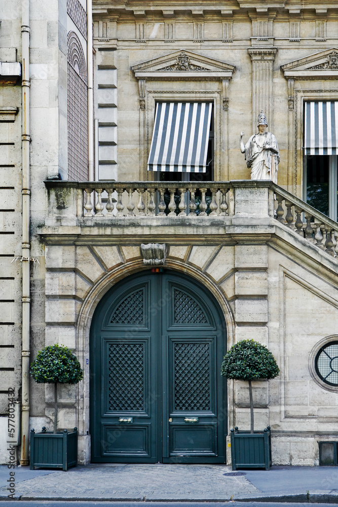 Paris ancient stone building with wooden carved double doors, stone ...
