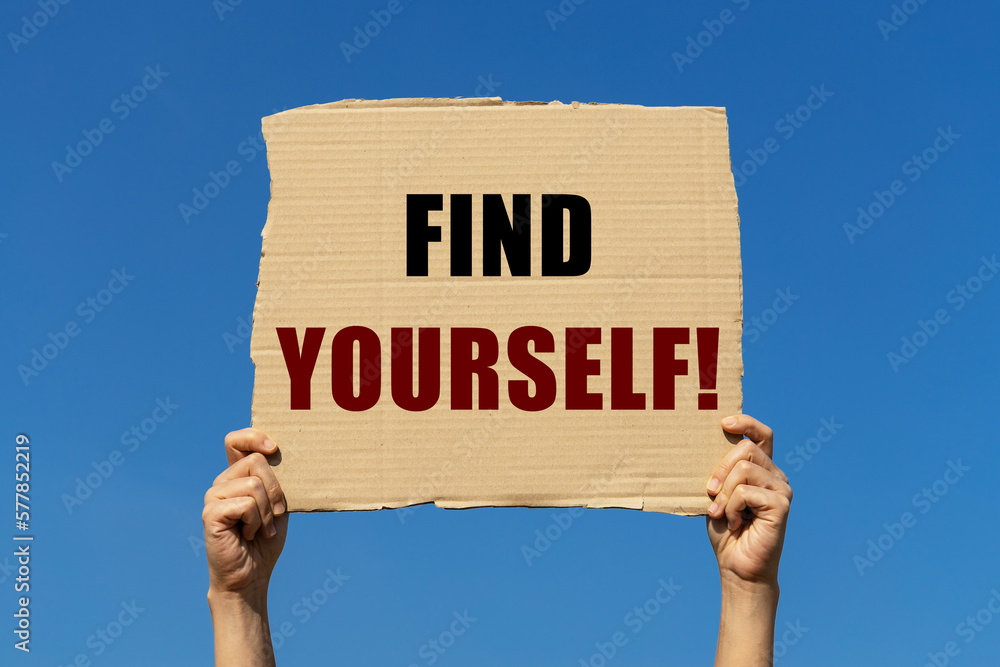Find yourself text on box paper held by 2 hands with isolated blue sky ...