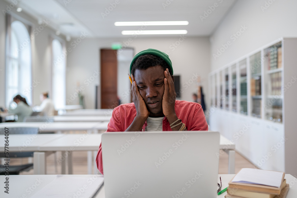 Education and mental health. Stressed overwhelmed african american guy ...