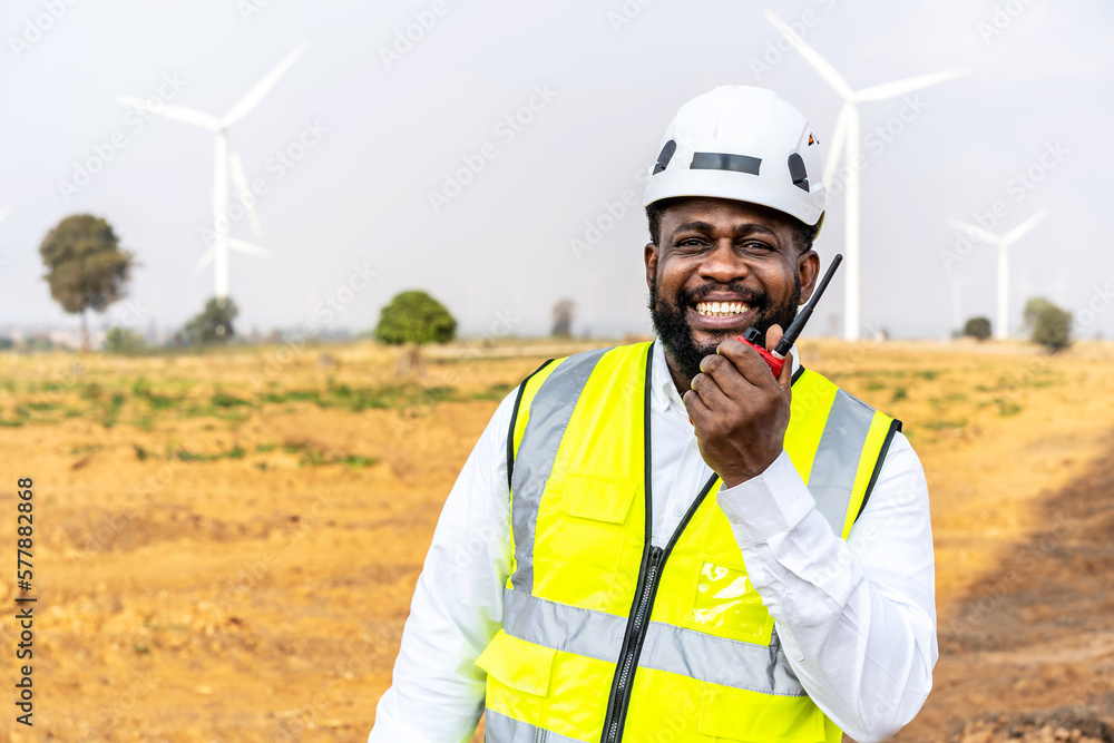 Front view of happy african american man engineer wearing safety helmet ...