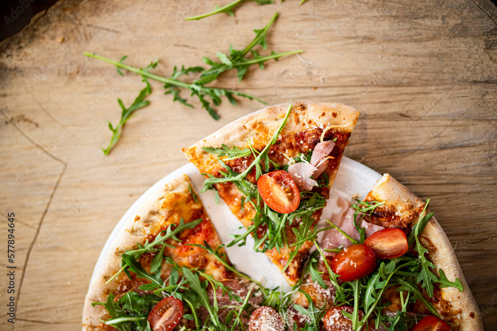 Pizza sliced - straight from a wood-fired oven. Isolated on a brown ...