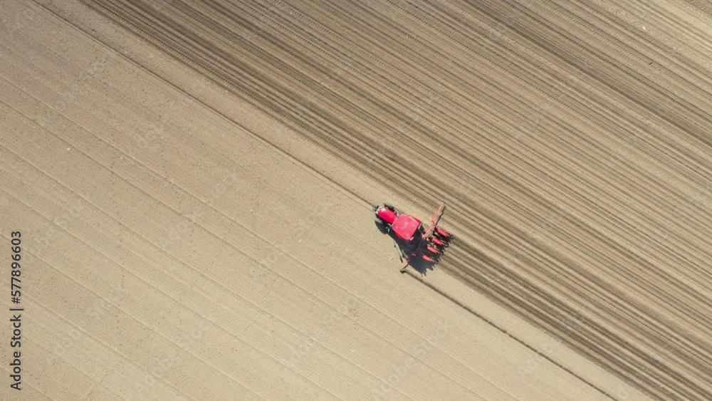 Video Stock Above top view, of tractor as pulling mechanical seeder ...